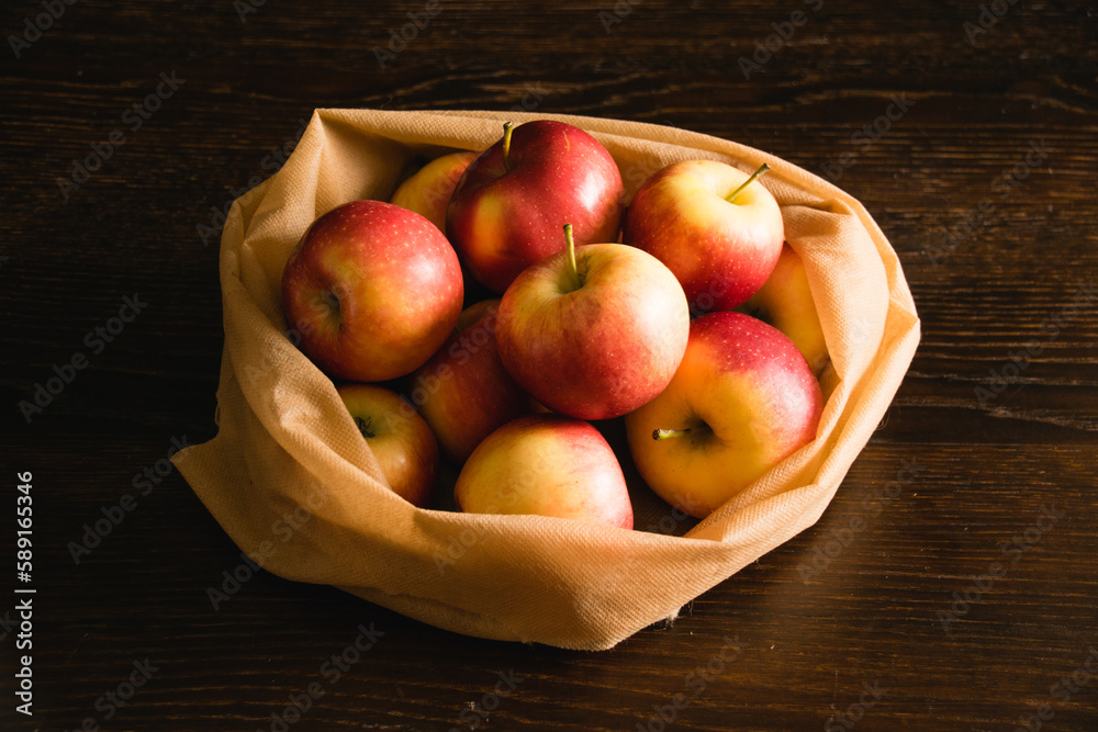 Delicious apples in a reusable bag for fruits and vegetables. Earth day ...
