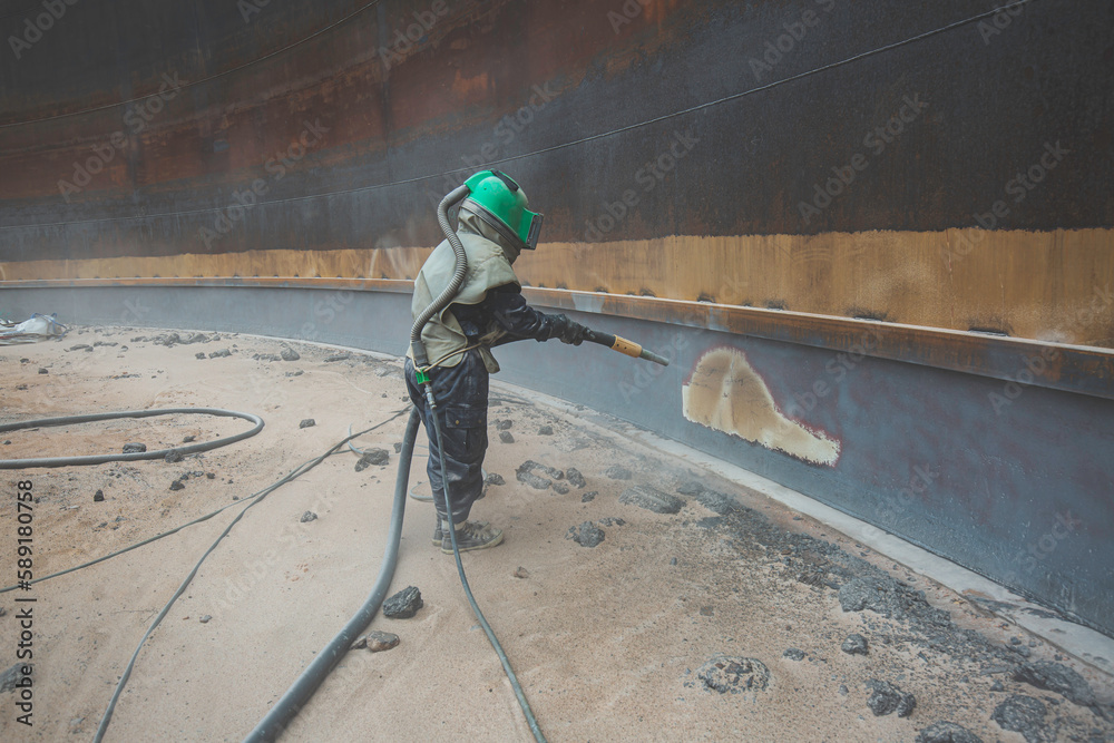 Female worker surface corrosion plate preparation by sand blasting ...