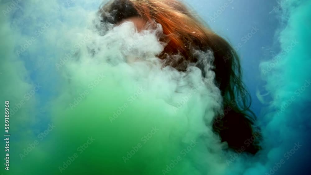 enigmatic redhead woman in mysterious depth of sea or ocean, silhouette ...