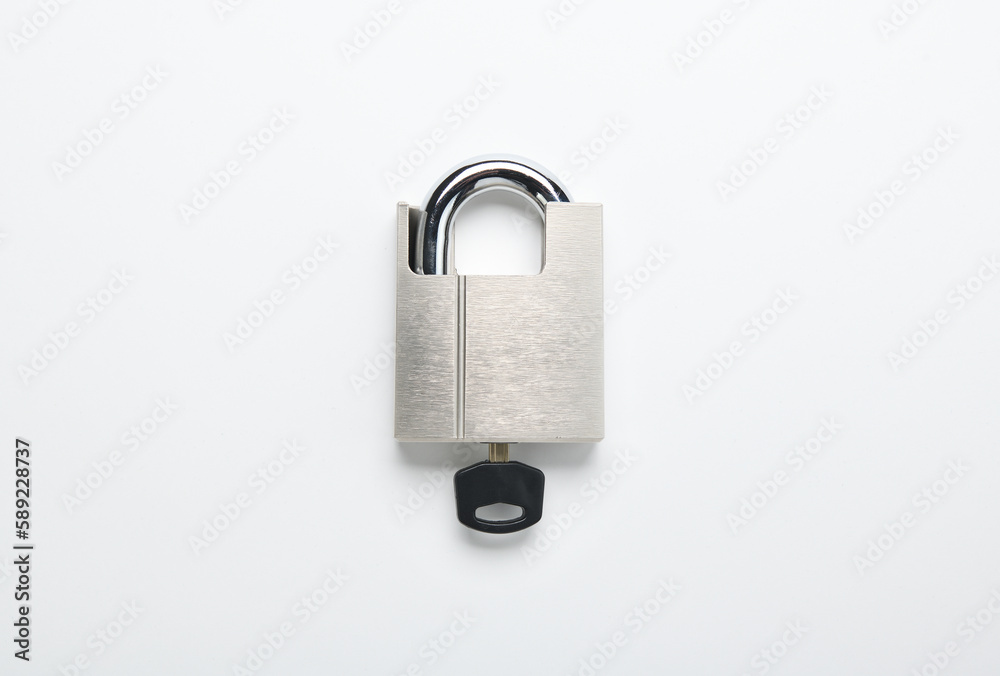 A chrome padlock with a key on a white background illustrates the key ...