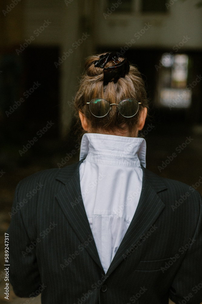 Person wears white shirt and black jacket backwards. Woman wears ...