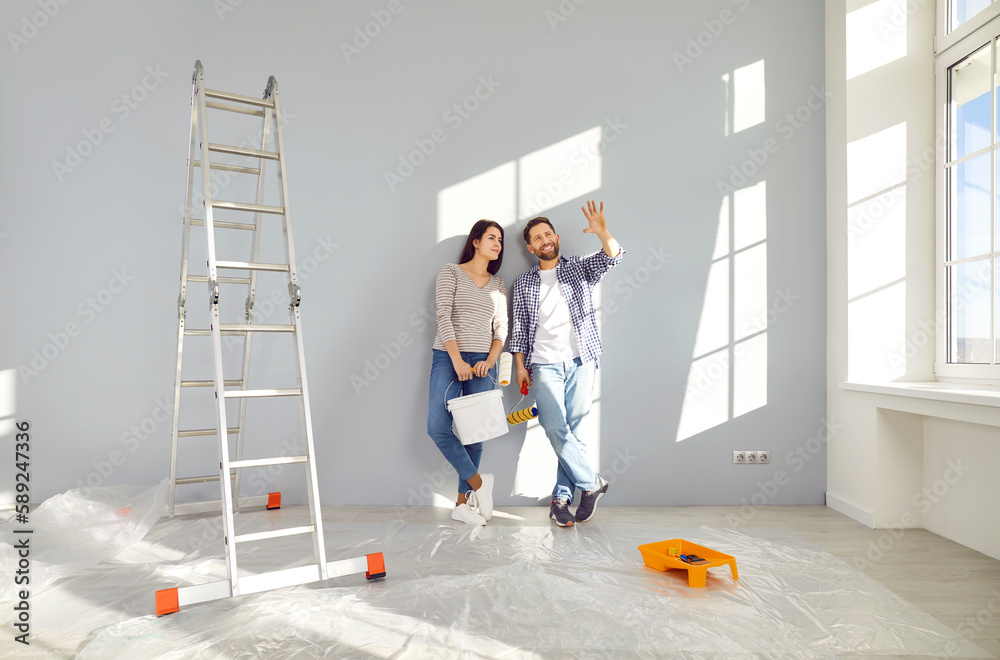 Young family couple doing renovations at home. Happy man and woman ...