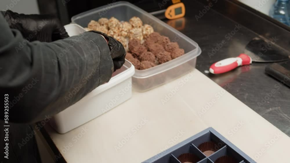 Woman chef confectioner making chocolate candy, pouring cacao for ...