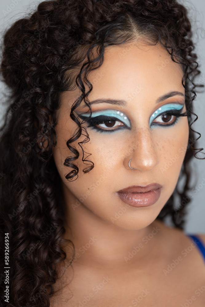 Boudoir portrait of a beautiful mixed race woman in her late 20s. She ...