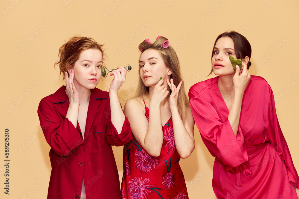 Morning routine. Beautiful young girls in pajamas taking care after ...