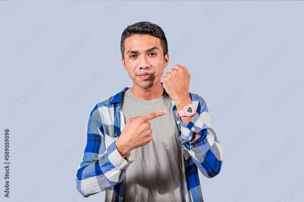 Person pointing at his watch looking at the camera. Friendly man ...