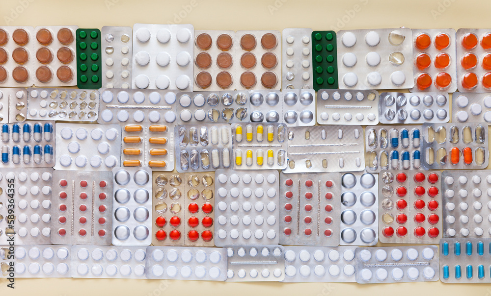 Medical background from rows of pills, capsules, lozenges, vitamins and ...