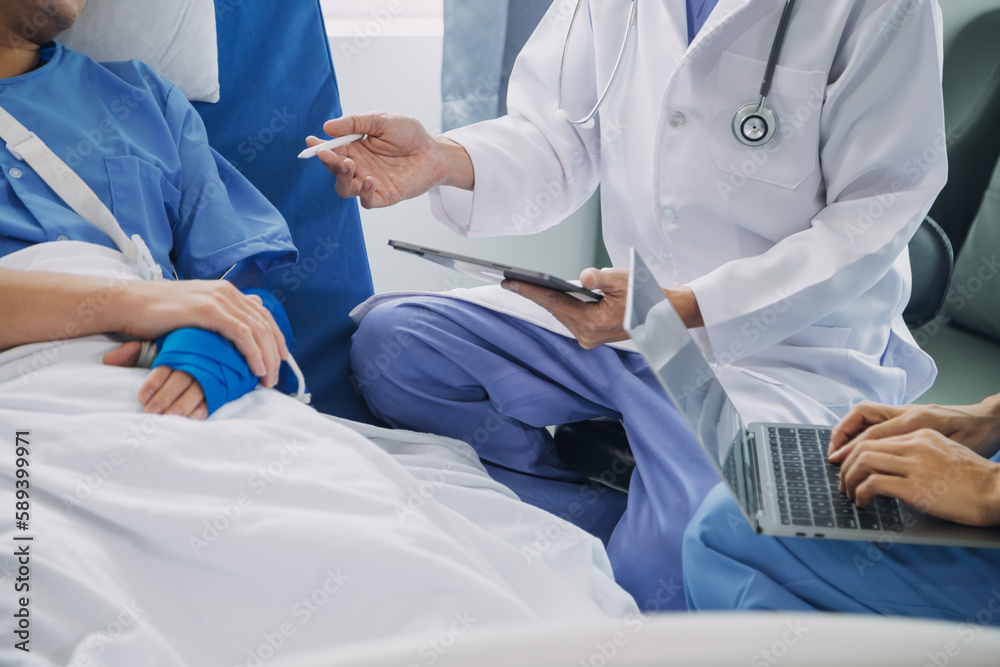 Injured patient showing doctor broken wrist and arm with bandage in ...