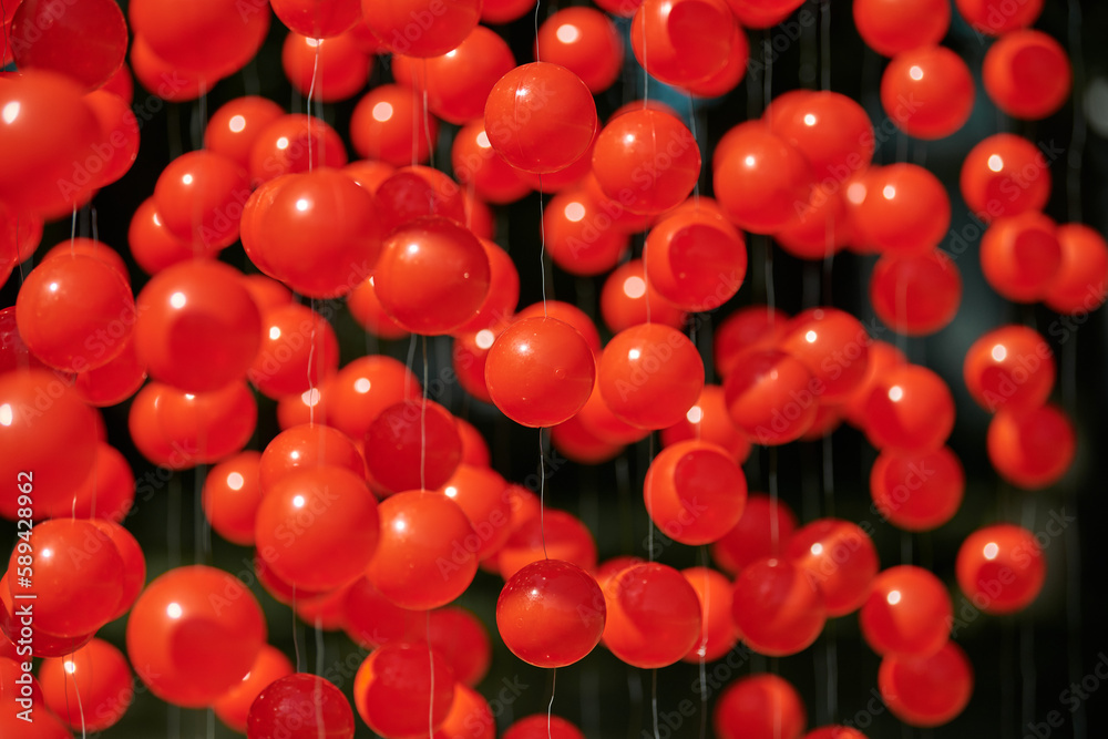 Red balls suspended on wire, outdoor art object symbolizing blood cells ...