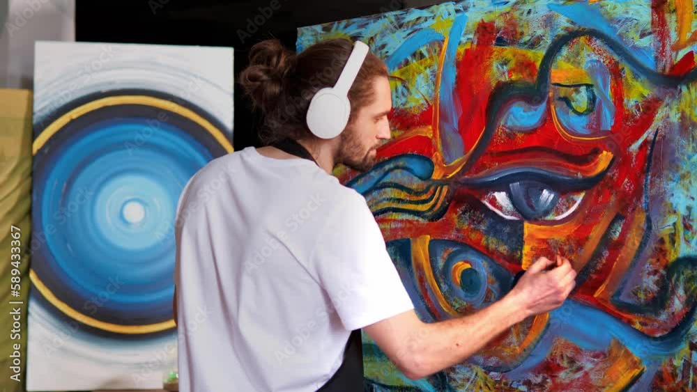 Focused creative artist is in process of producing a masterpiece. Man ...