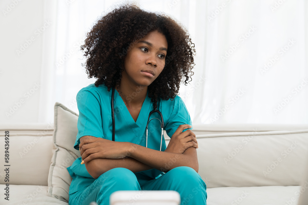 Stressed young female doctor while working in hospital. Tired female ...