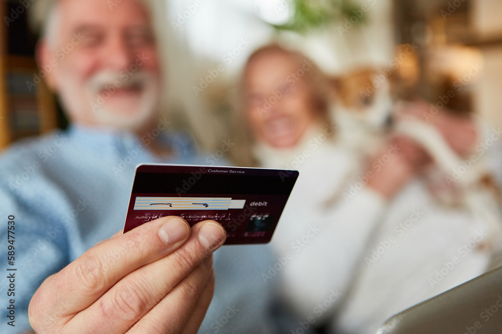 Hand of a senior holds credit card for e-commerce Stock Photo | Adobe Stock