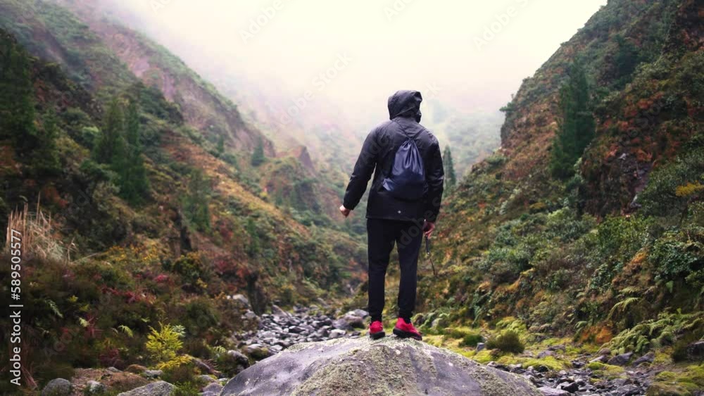 Track trail through mountains walking by muddy paths after rain amidst ...