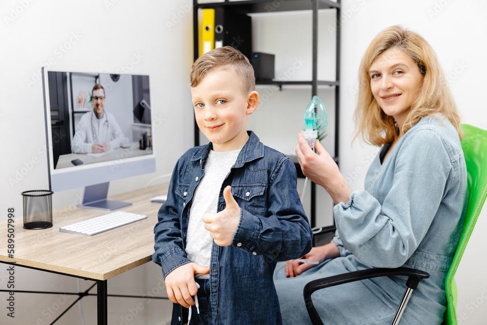 Caucasian little boy making inhalation with nebulizer at home. A young ...