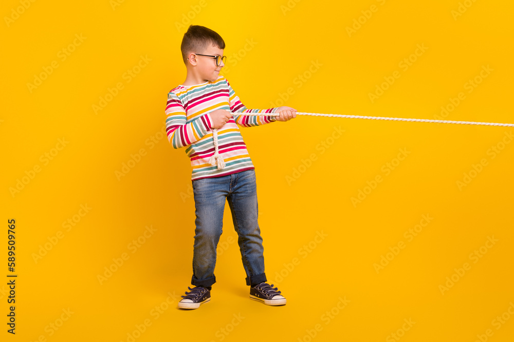 Full profile side photo of sweet kid boy playing outdoors pull string ...