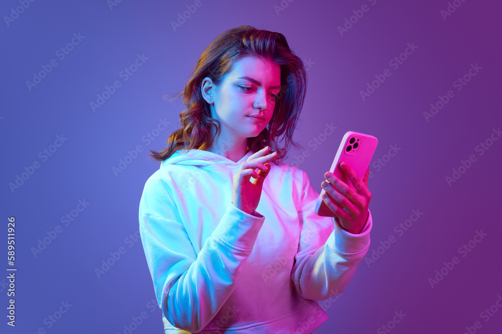 Young girl typing messages on mobile phone, reading news and social ...