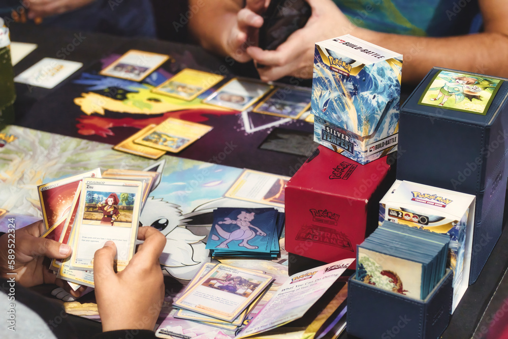 Two unrecognizable white Caucasian kids playing with Pokemon trading ...