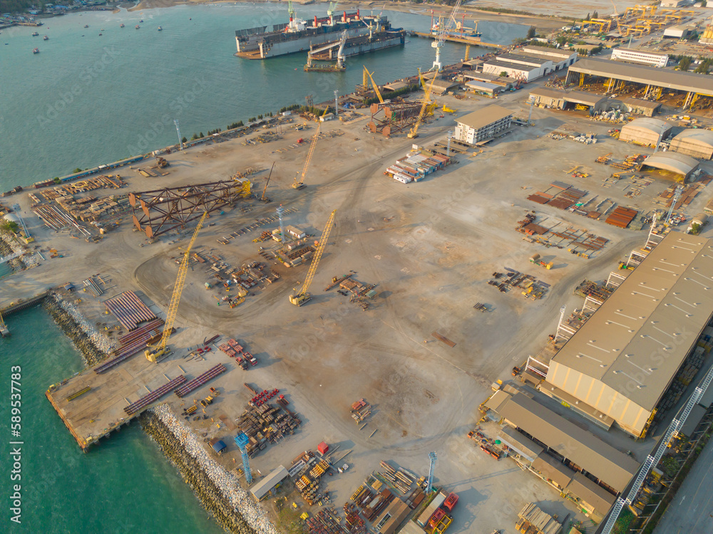 Aerial view of busy industrial under construction site workers working ...