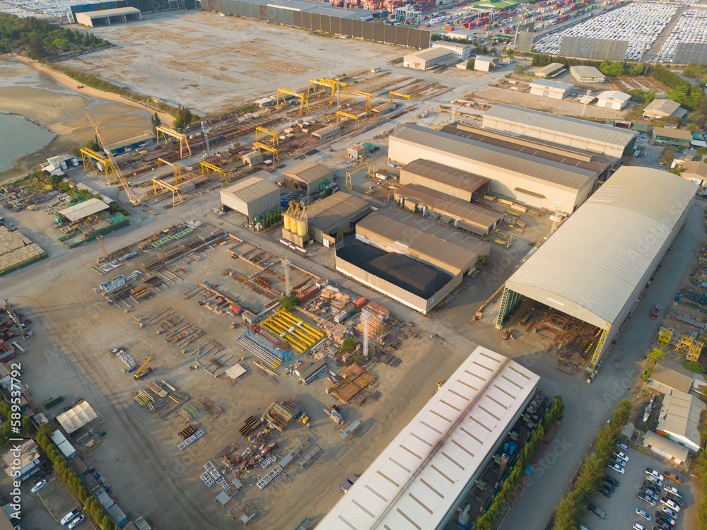 Aerial view of busy industrial under construction site workers working ...
