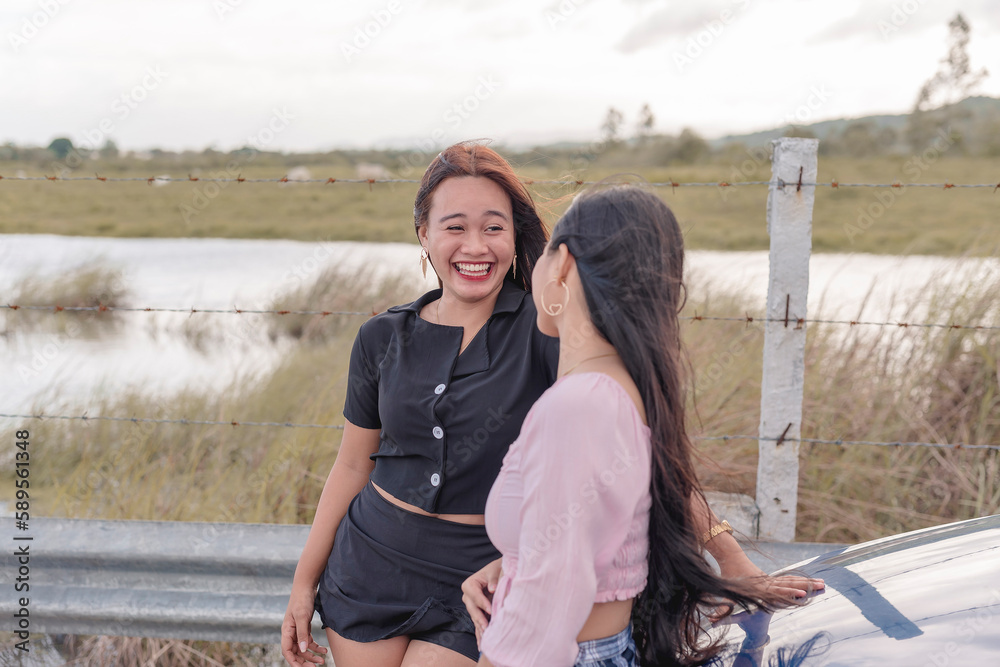 Two good looking women standing on the side of the road out of nowhere ...