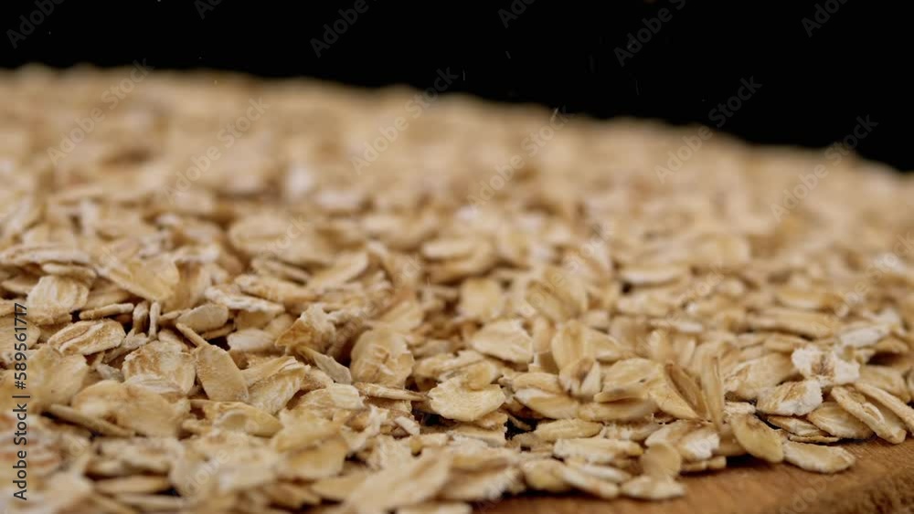 Dry Oat Flakes Falling in Pile Raw Oatmeal on Black Rotating Background ...