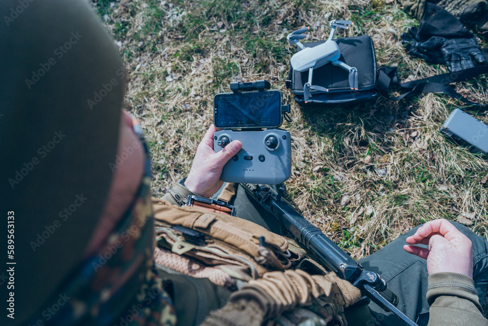 Modern army soldiers using aerial drone for artillery guidance and ...