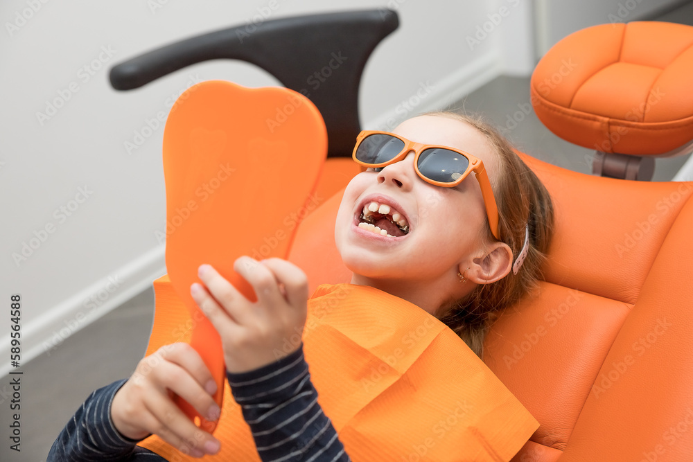 Dental plate. Expansion of the jaw in a child. teenage girl holding an ...