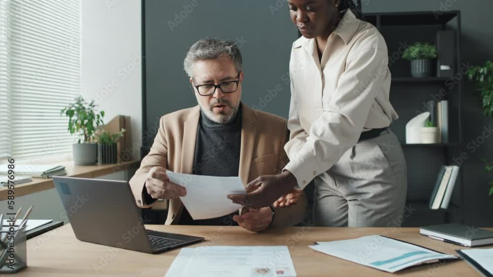 Medium shot of Caucasian senior businessman sitting in office beside ...