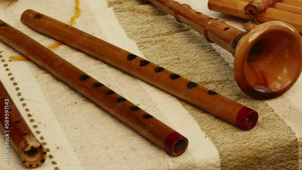close-up shot of different types of medieval wooden flutes on display ...