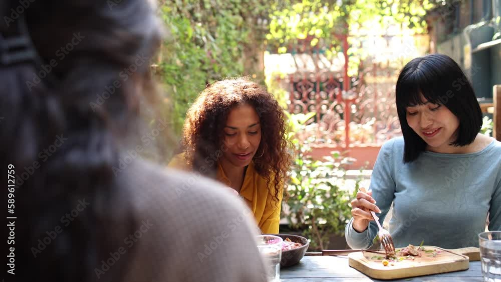 Diverse friendship, three women talking at the garden while having a ...