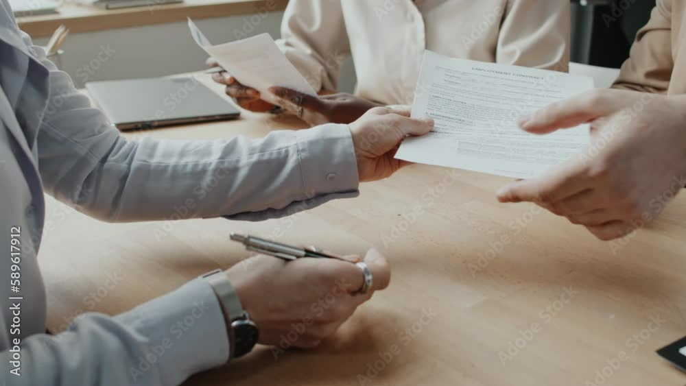 Close up of Caucasian female applicant signing job agreement and ...
