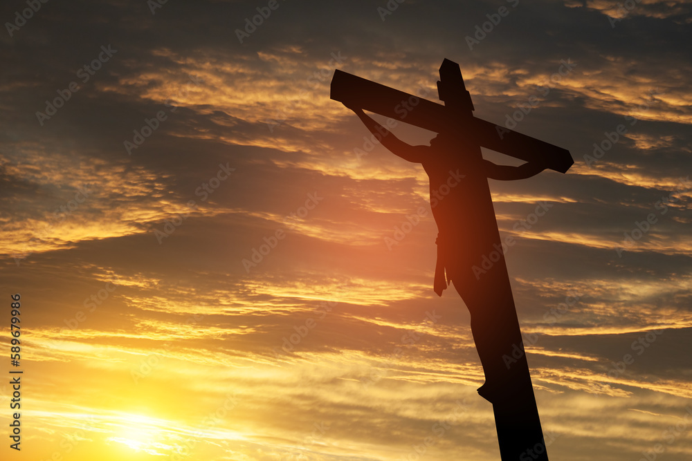 Silhouette of the crucified Jesus Christ on the cross on background of ...