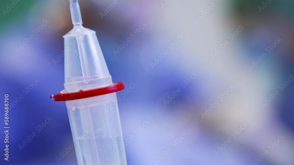 Reservoir of drop counter is filling with medicines. Saline solution ...