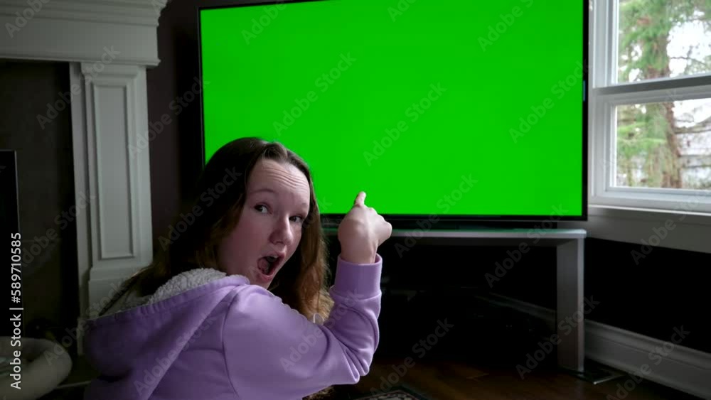 Vidéo Stock Watching Tv Green Screen Dolly Shot. Ponytail girl watching ...