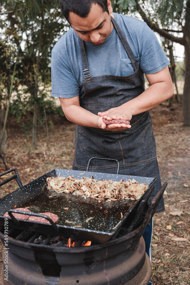 Man Grilling Hamburgers