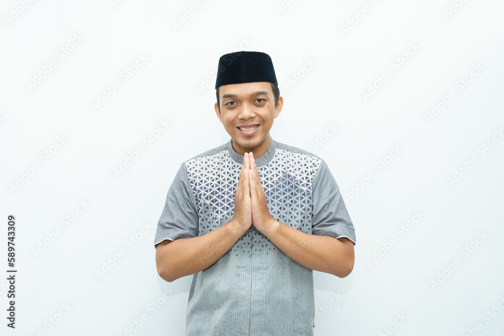 Portrait of an Asian Indonesian Muslim man placing his hands in front ...