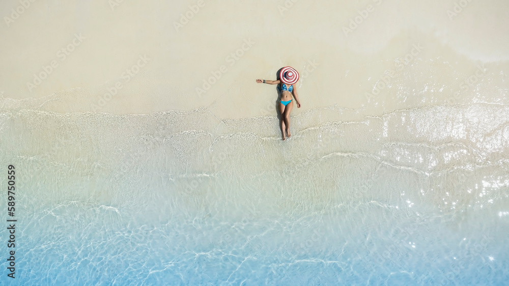 Aerial view of woman on the beach as waves with water in sand beach ...