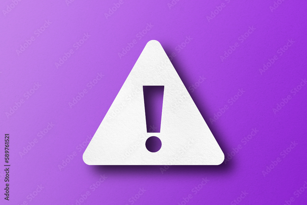 White paper punched into the shape of an exclamation mark. warning sign ...