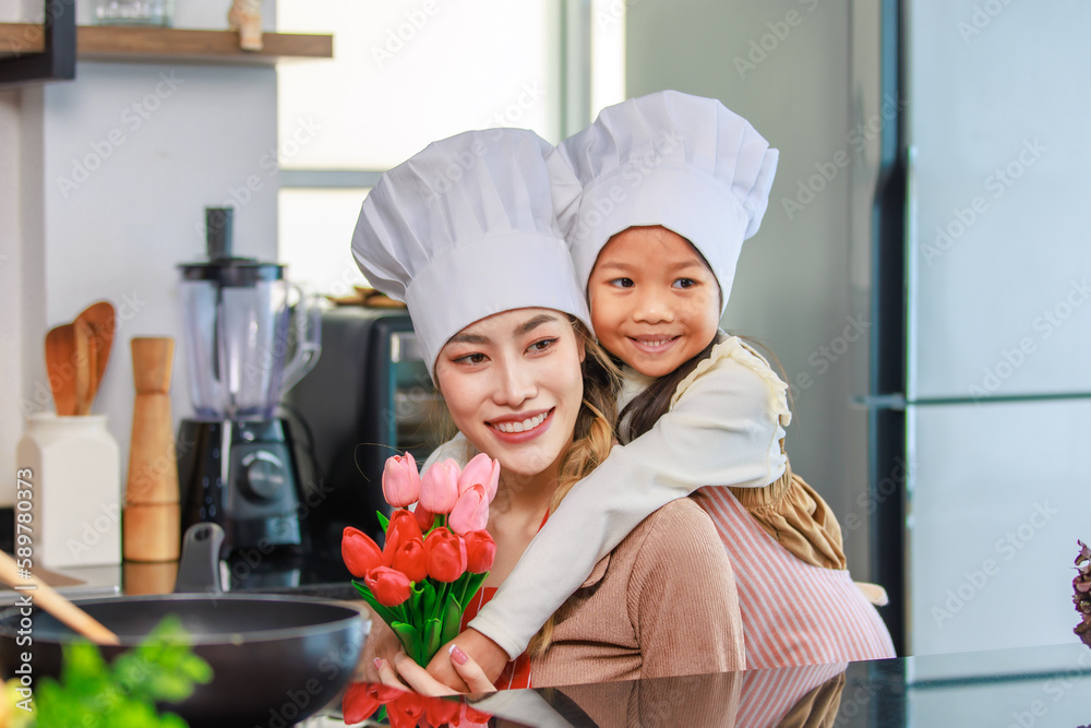 Asian little cute girl daughter smiling holding tulip flower bouquet ...