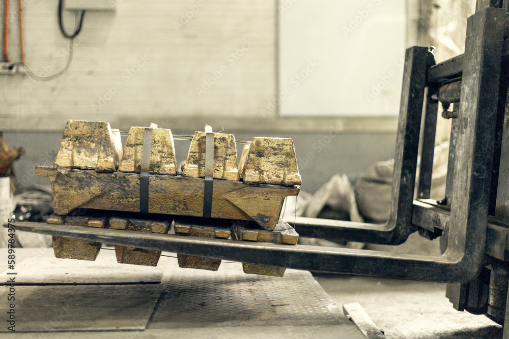 loader lifts a stack of brass ingots in a casting factory Stock Photo ...