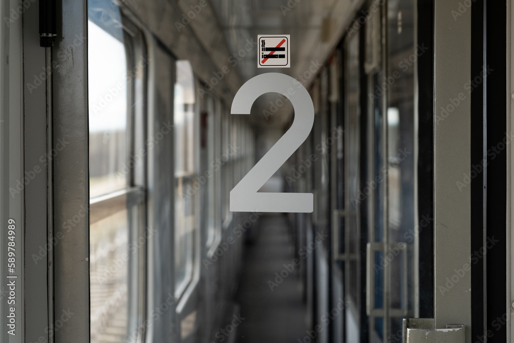 Passenger train corridor glass door with second class number and no ...