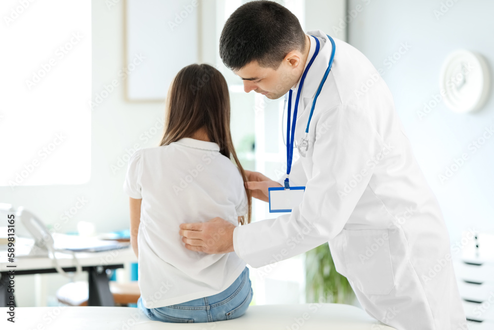 Doctor checking posture of little girl in clinic Stock Photo | Adobe Stock