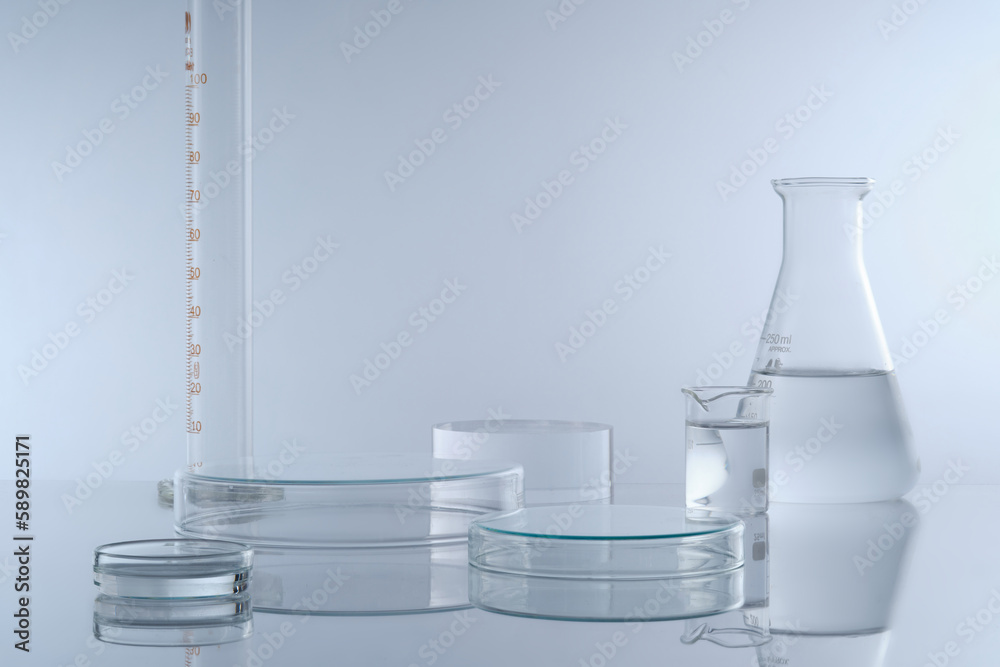 Minimal background with laboratory glassware containing colorless ...