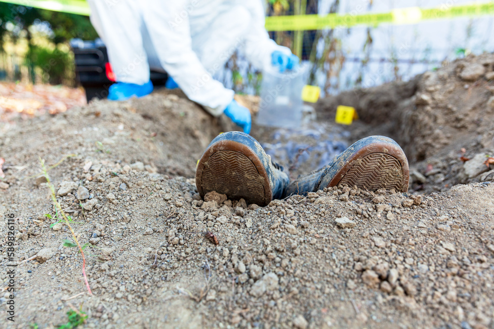 Forensic science specialist work at a war crime scene investigation ...