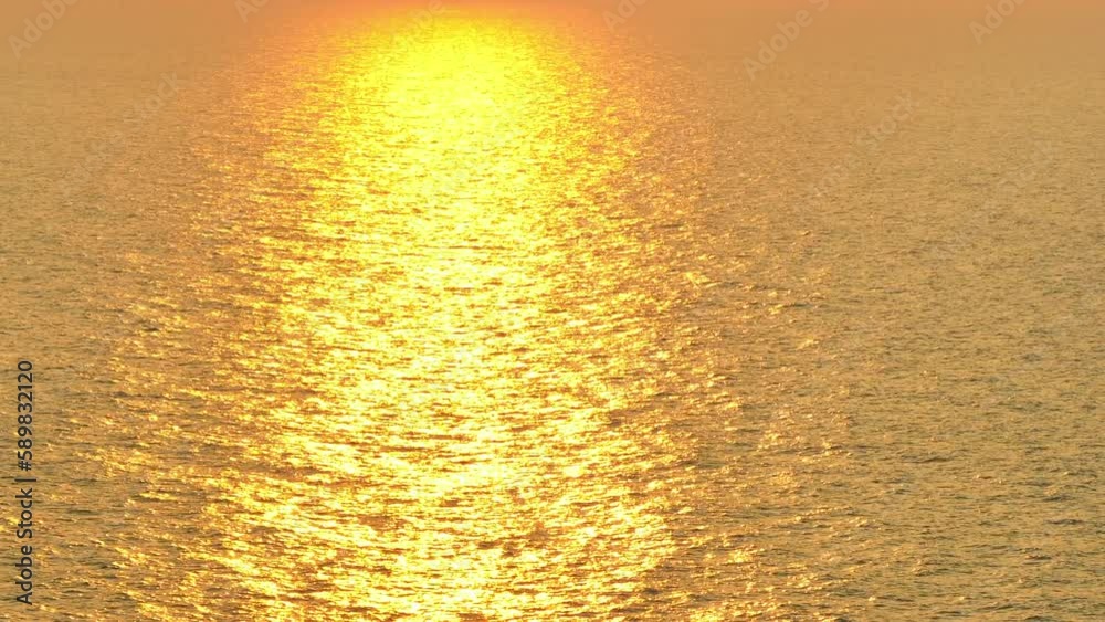 The sun is just starting to rise above the horizon, casting a warm. The ...