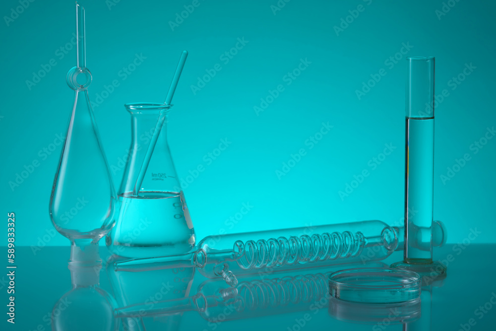 Over a blue background, erlenmeyer flask, a tube with spiral pipe ...