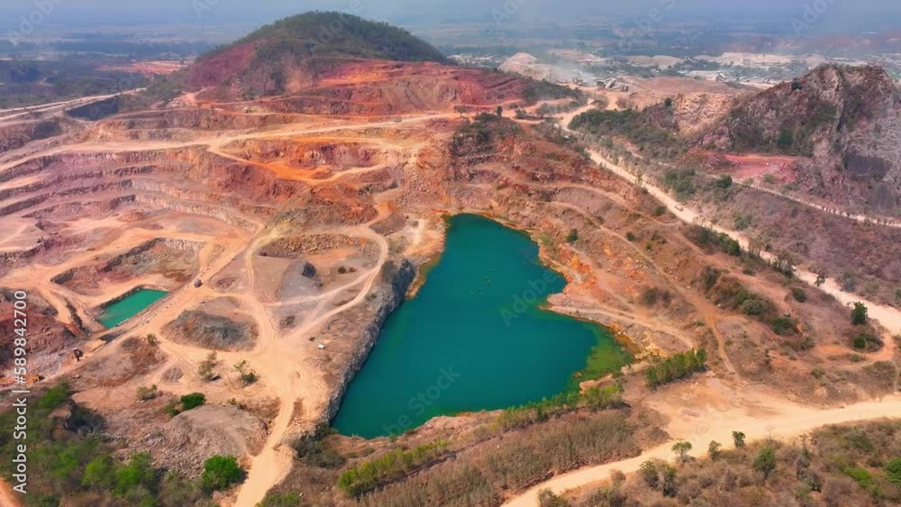 A quarry displays a large open pit where rocks, gravel, sand, or ...