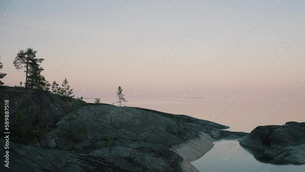 Calm morning at dawn on lake, smooth surface of water in secluded wild ...