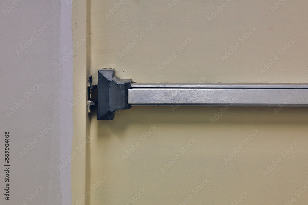 Emergency fire exit door. Closed up latch and rusty door handle of ...