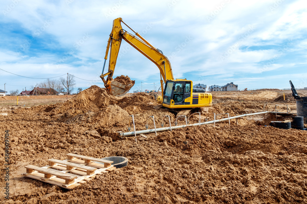 Excavator dig the trenches at a construction site. Trench for laying ...